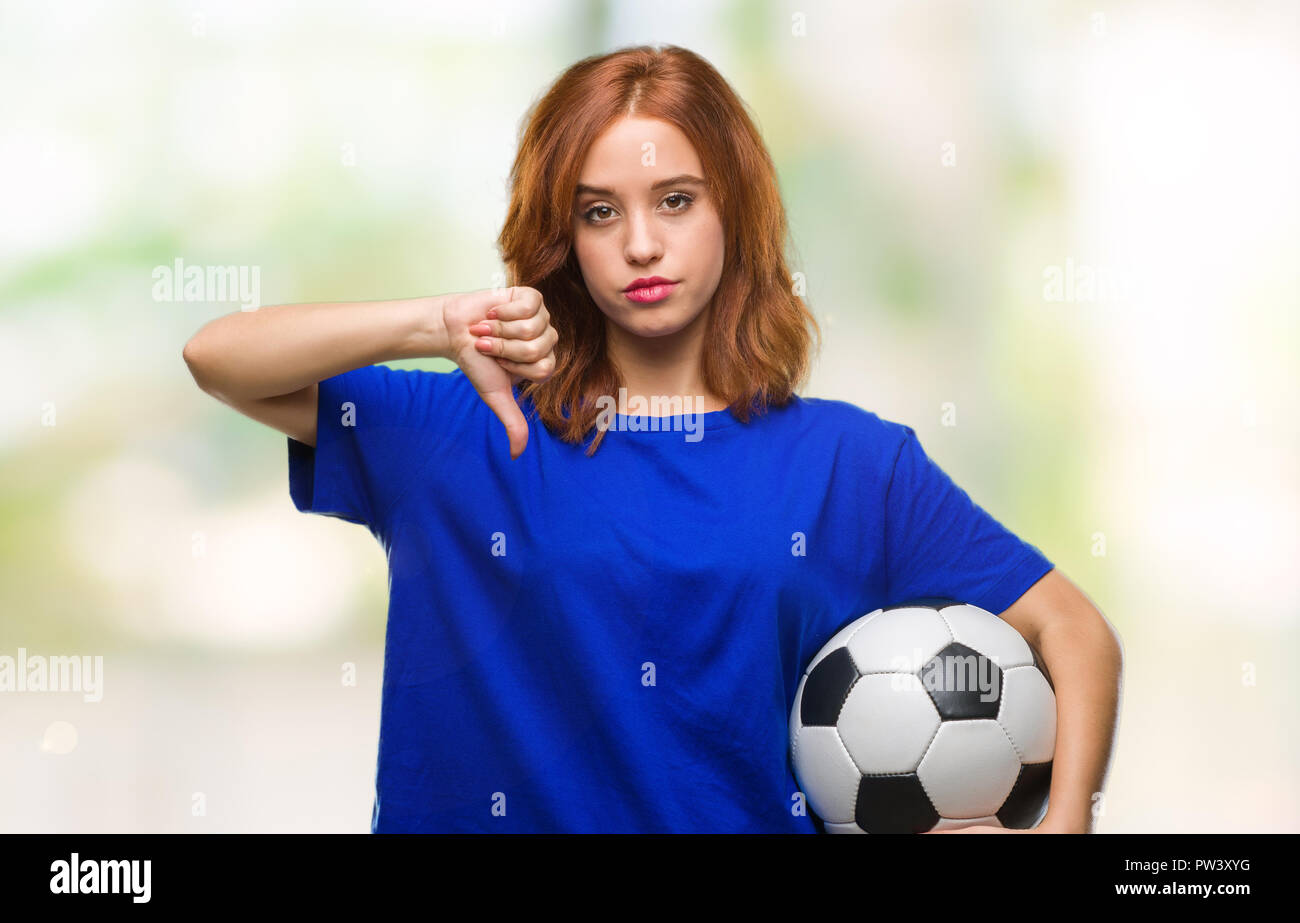 Young beautiful woman over isolated background holding soccer football ...