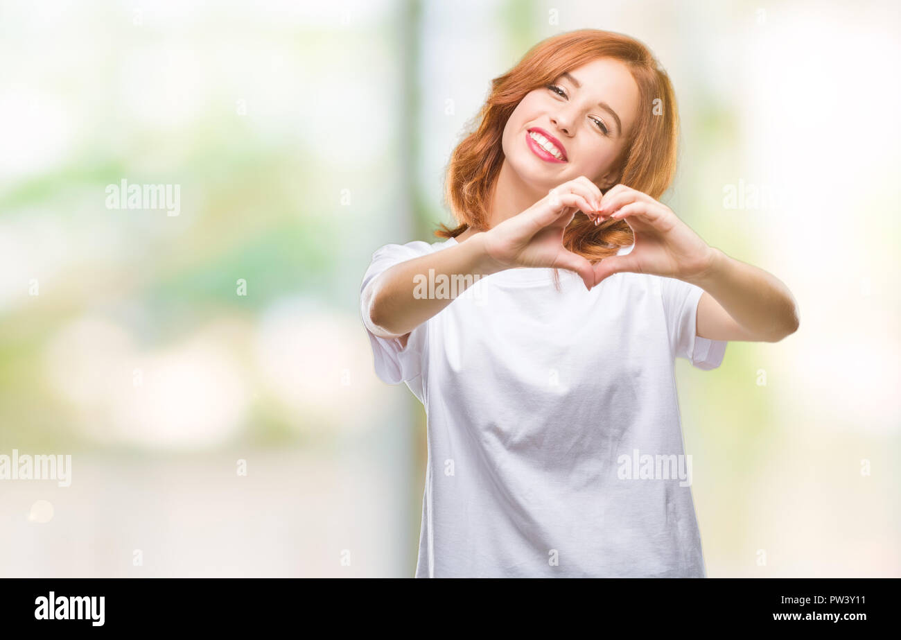 Young beautiful woman over isolated background smiling in love showing ...