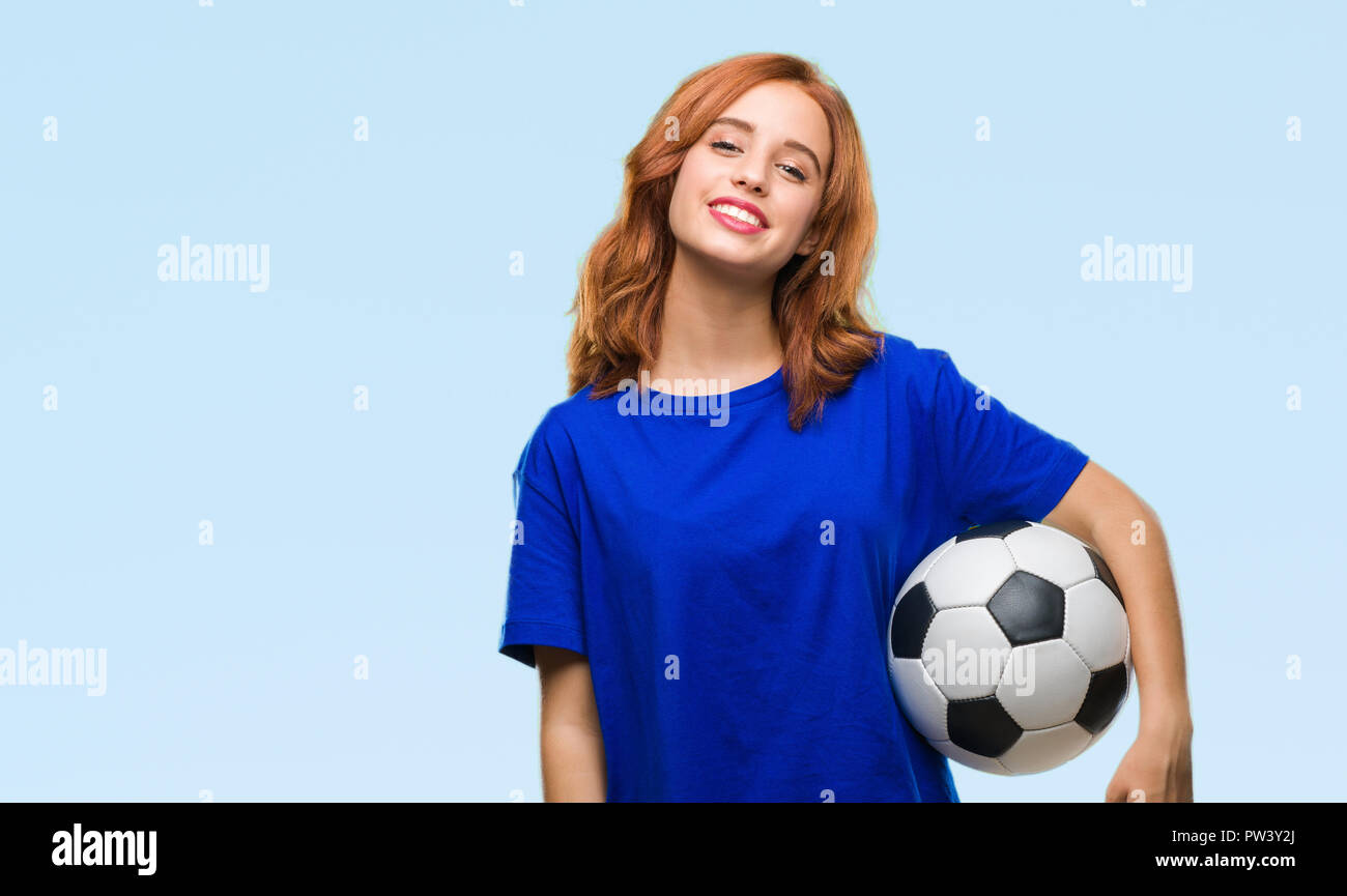 Young beautiful woman over isolated background holding soccer football ...
