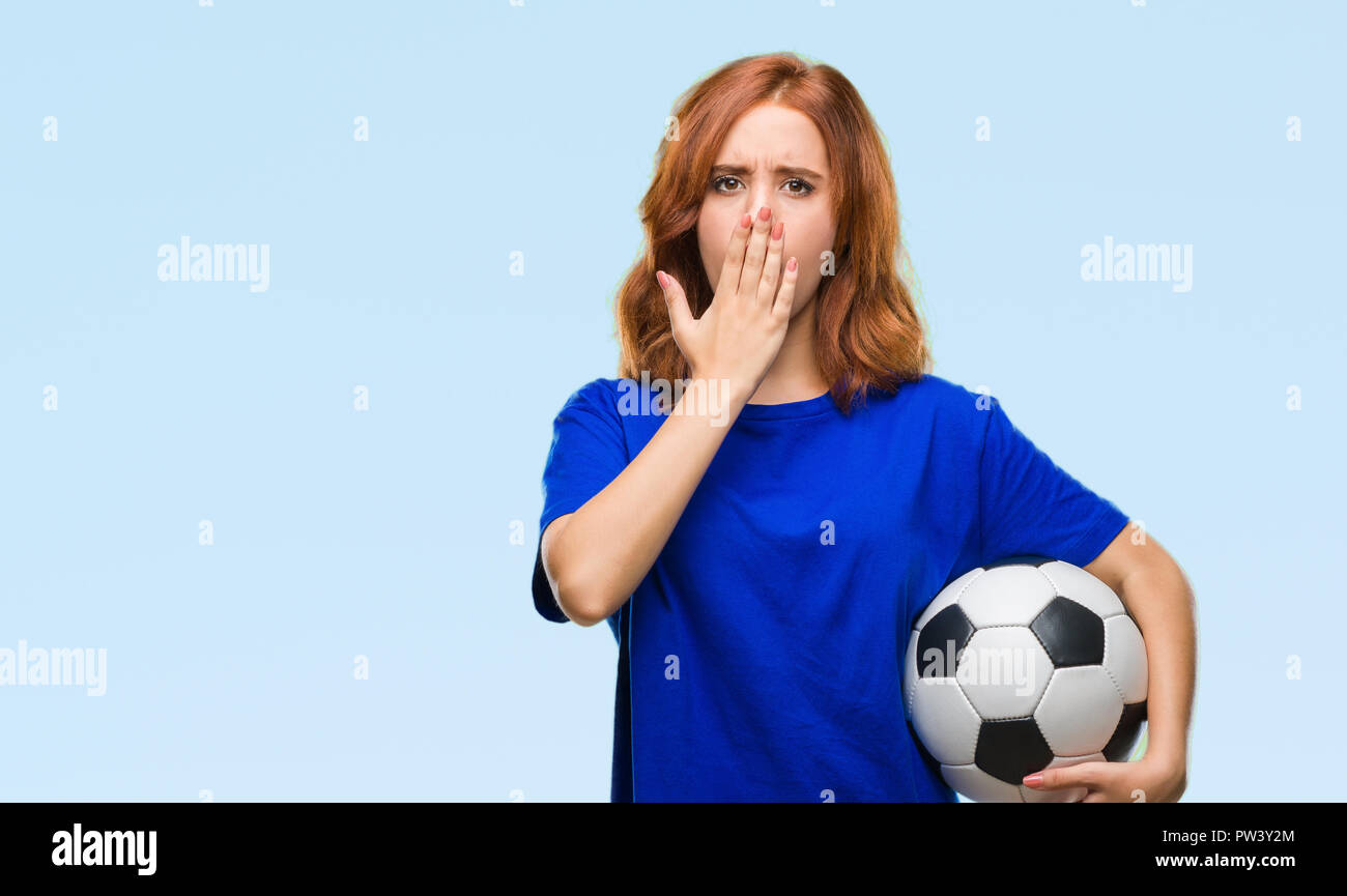 Young beautiful woman over isolated background holding soccer football ...