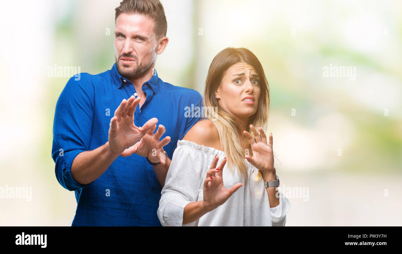 Young couple in love over isolated background disgusted expression ...