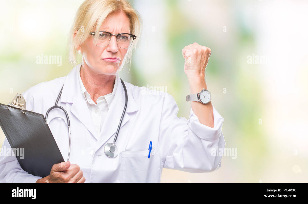 Middle age blonde doctor woman holding clipboard over isolated ...