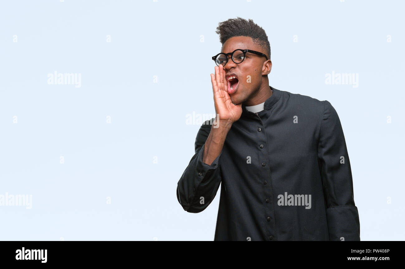 Young african american priest man over isolated background shouting and ...