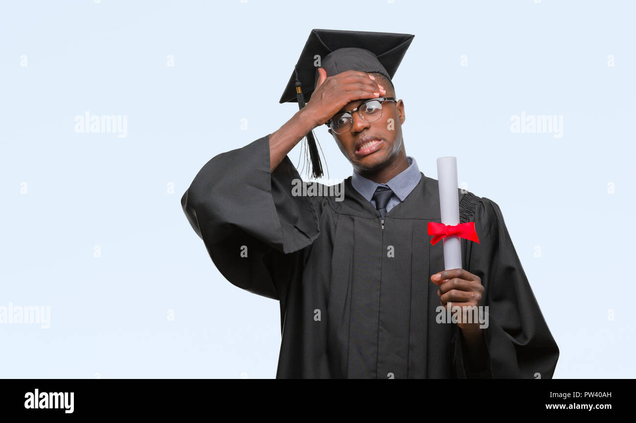 Young graduated african american man holding degree over isolated ...