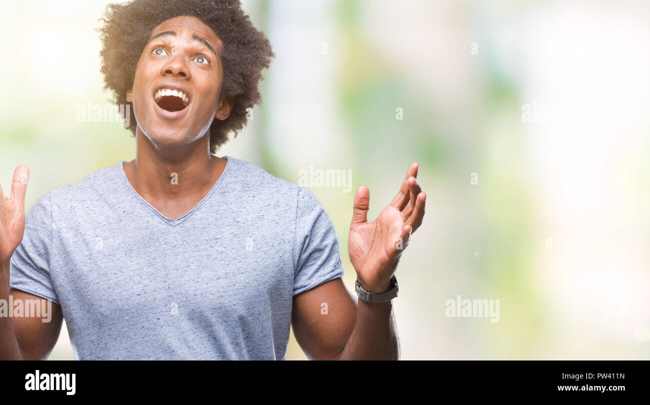Afro american man over isolated background crazy and mad shouting and ...