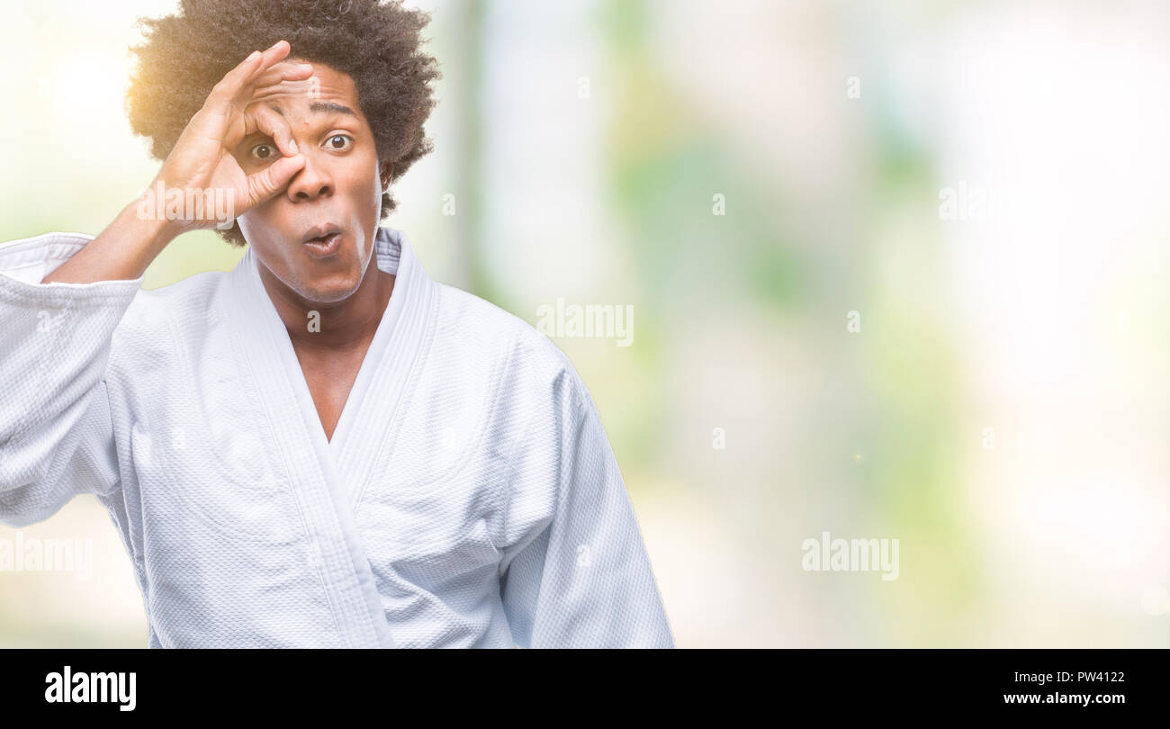 Afro american man wearing karate kimono over isolated background doing ...