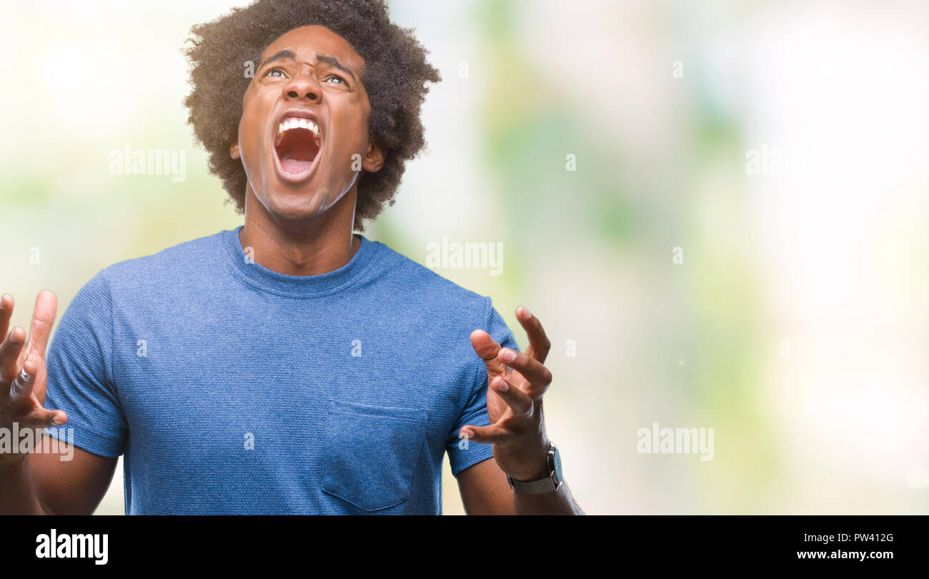 Afro american man over isolated background crazy and mad shouting and ...