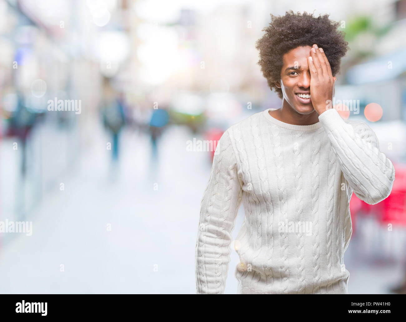 Afro american man over isolated background covering one eye with hand ...