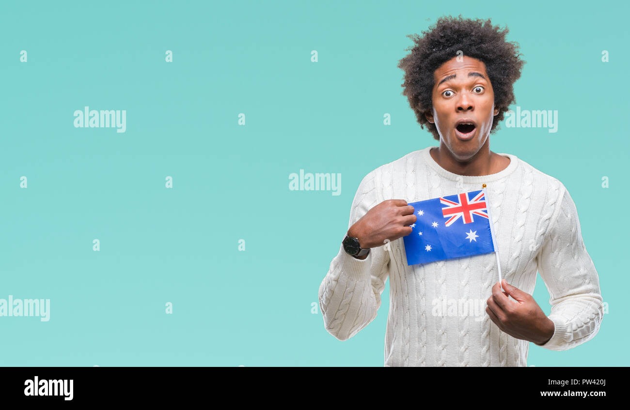 Afro american man flag of Australia over isolated background scared in ...