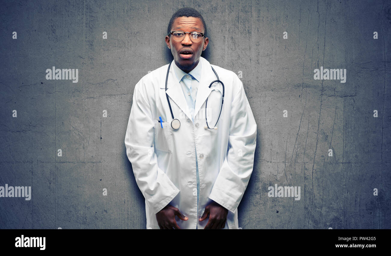 Young black doctor, medical professional scared in shock, expressing ...
