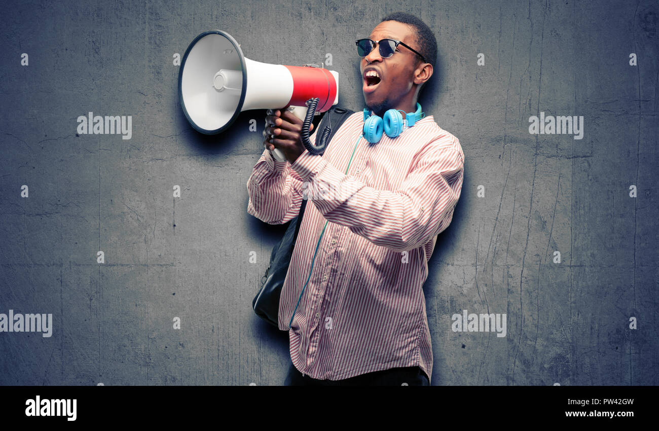African black man student communicates shouting loud holding a ...
