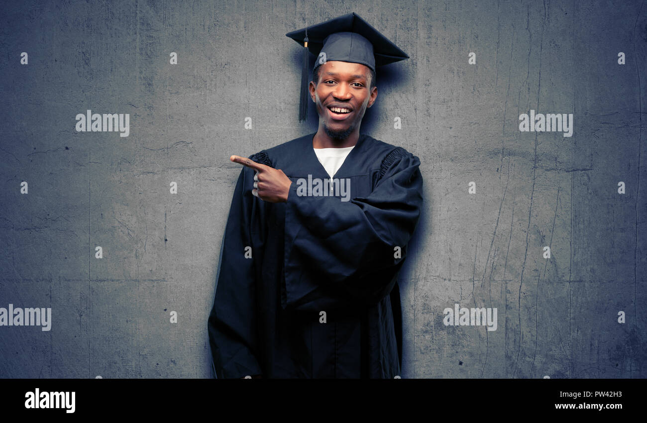 Young african graduate student black man pointing away side with finger ...