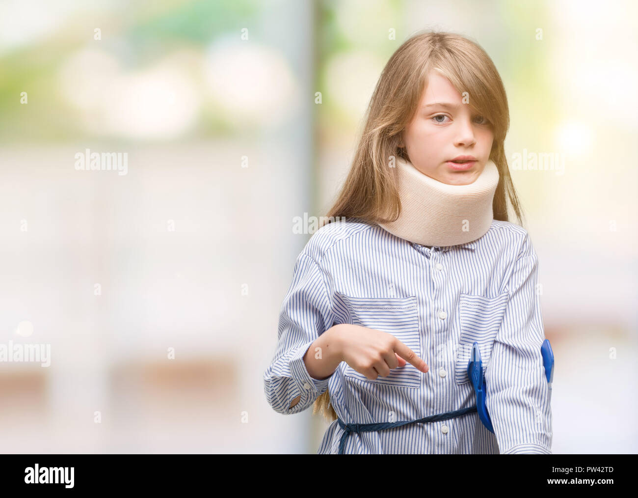 Young blonde child injured wearing neck collar and crutches very happy ...
