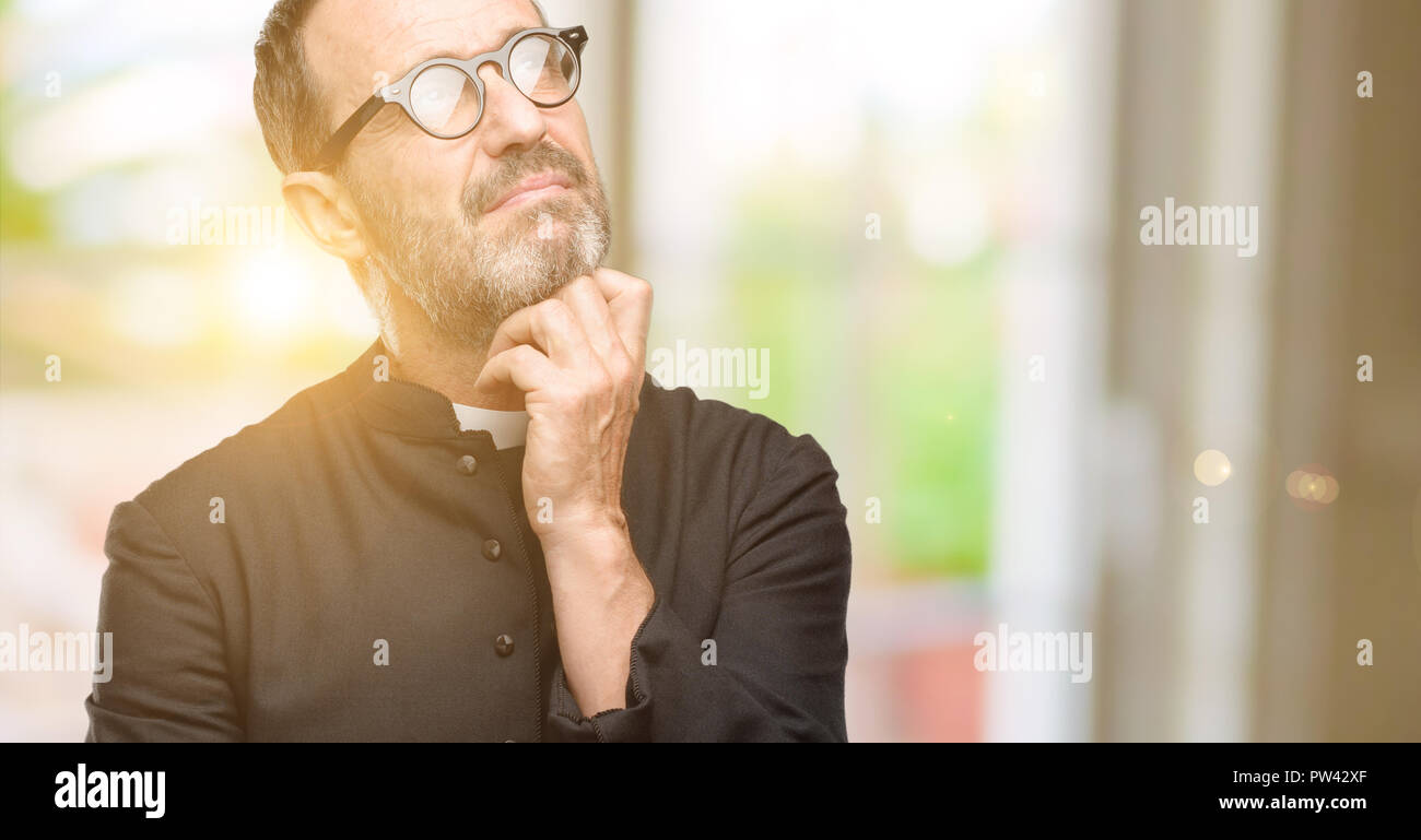 Priest religion man thinking and looking up expressing doubt and wonder ...