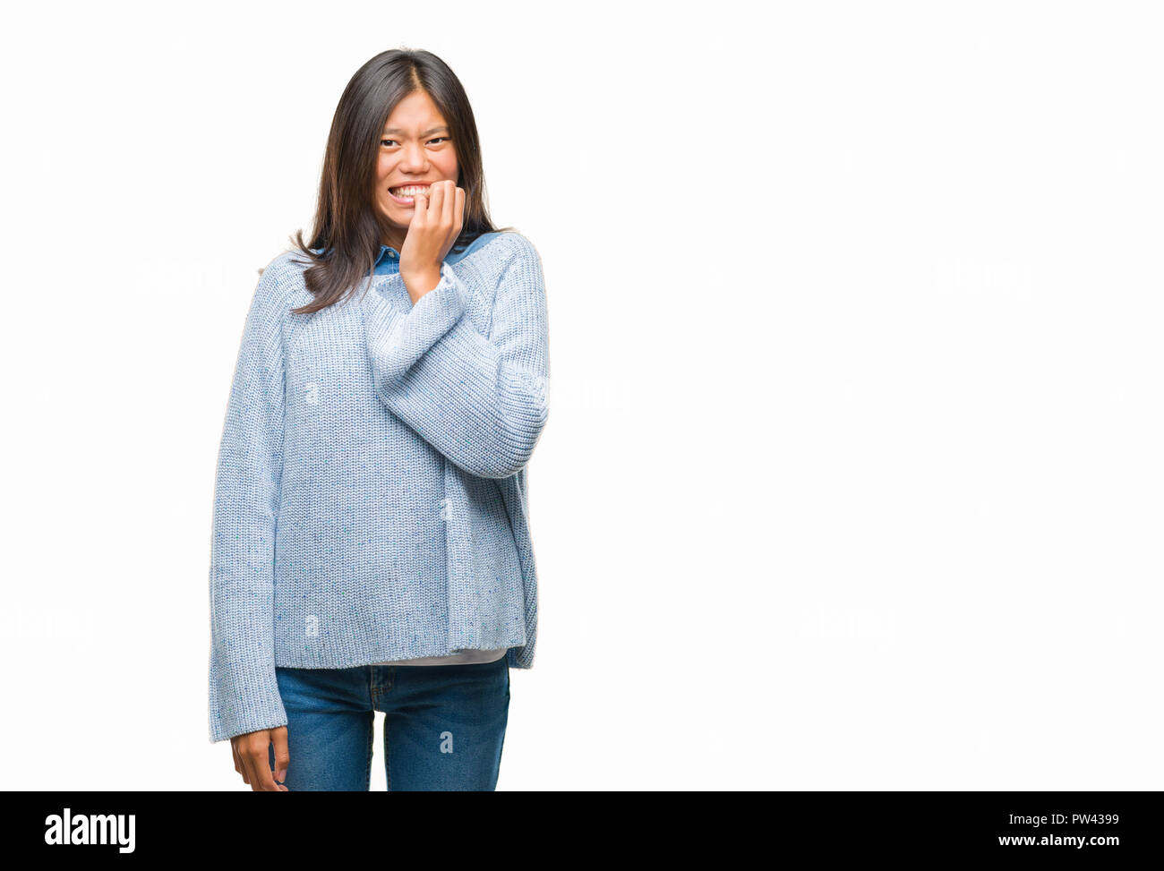 Young asian woman wearing winter sweater over isolated background ...