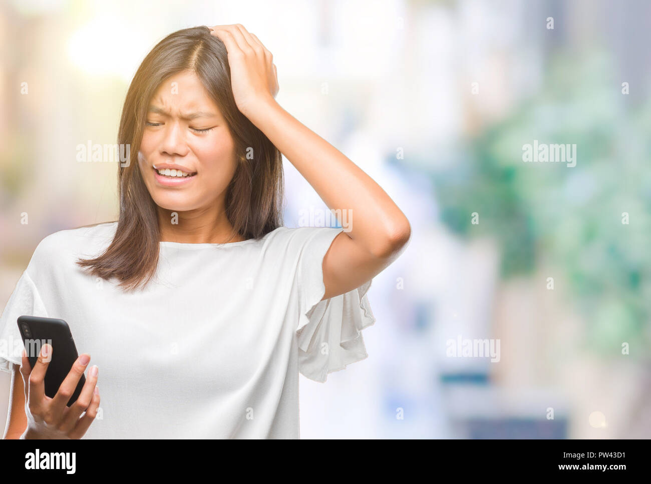 Young asian woman texting using smartphone over isolated background ...