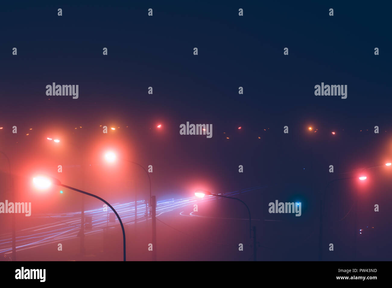 Neon lights of night city and motion traffic in fog. Retro colored ...