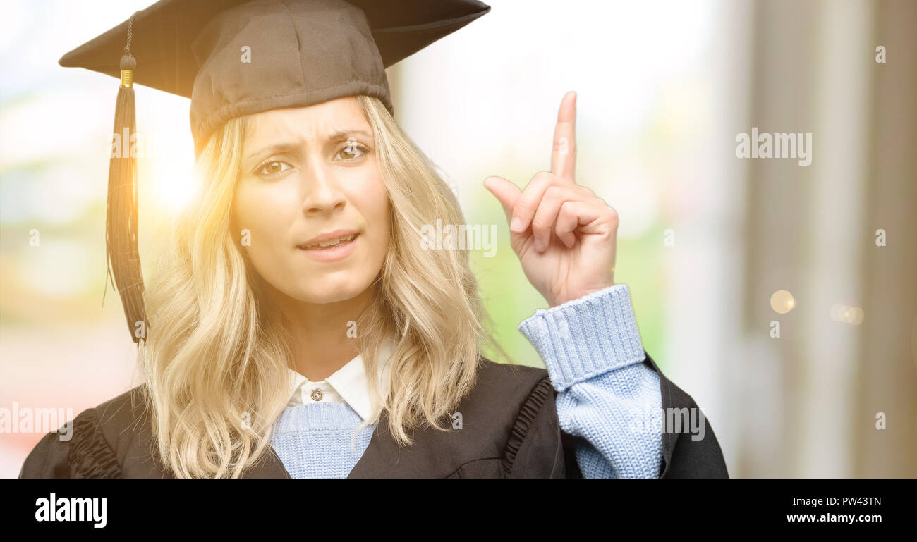 Young graduate woman happy and surprised cheering expressing wow ...