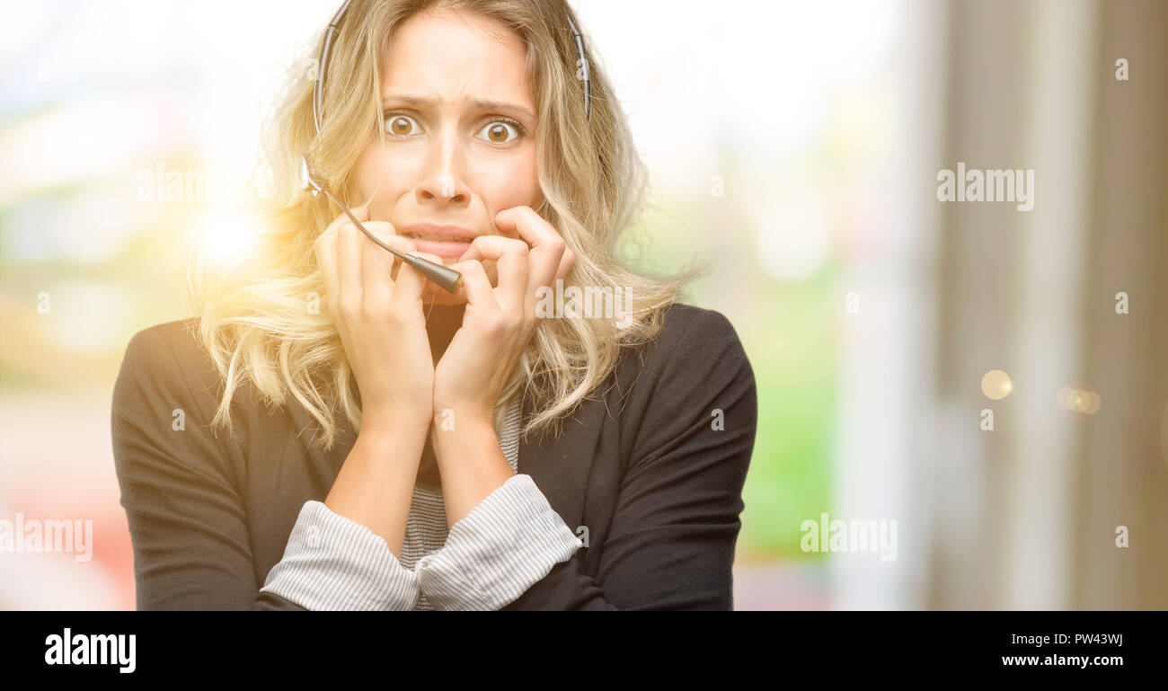 Young woman operator from call center terrified and nervous expressing ...