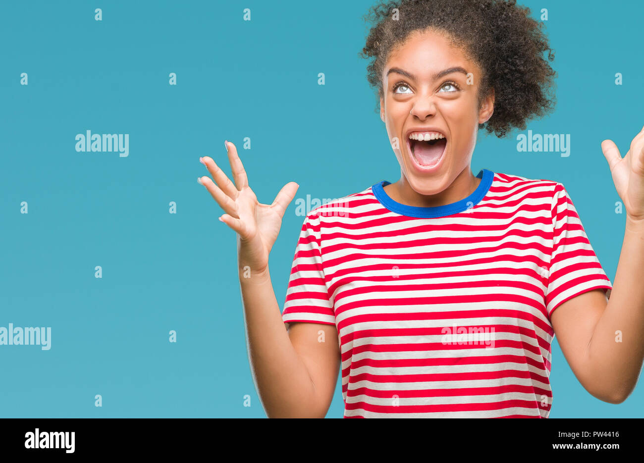Young afro american woman over isolated background crazy and mad ...