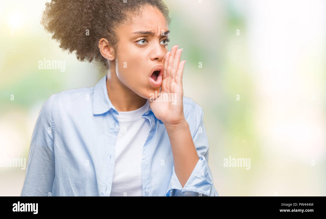 Young afro american woman over isolated background shouting and ...
