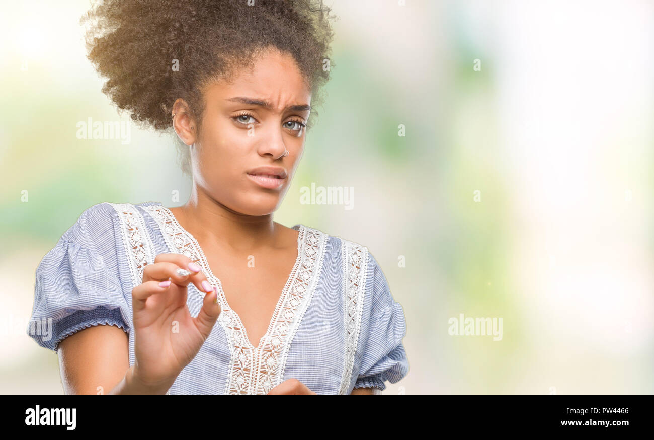 Young afro american woman over isolated background disgusted expression ...
