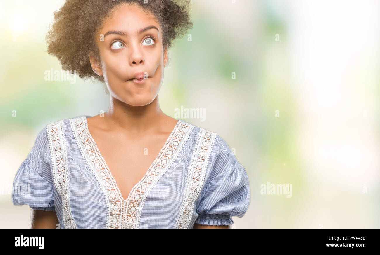 Young afro american woman over isolated background making fish face ...