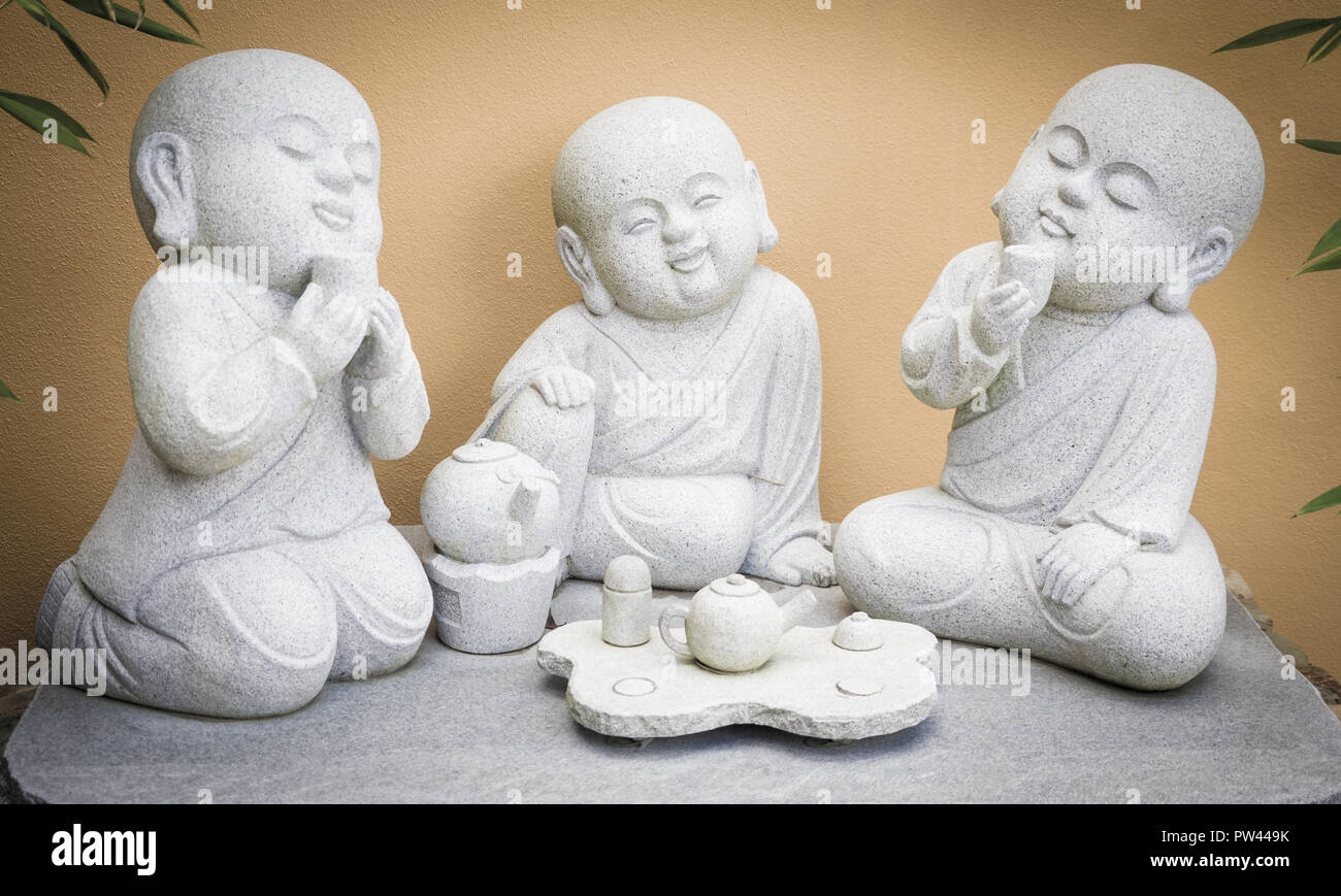 Buddhist statues having tea Stock Photo - Alamy