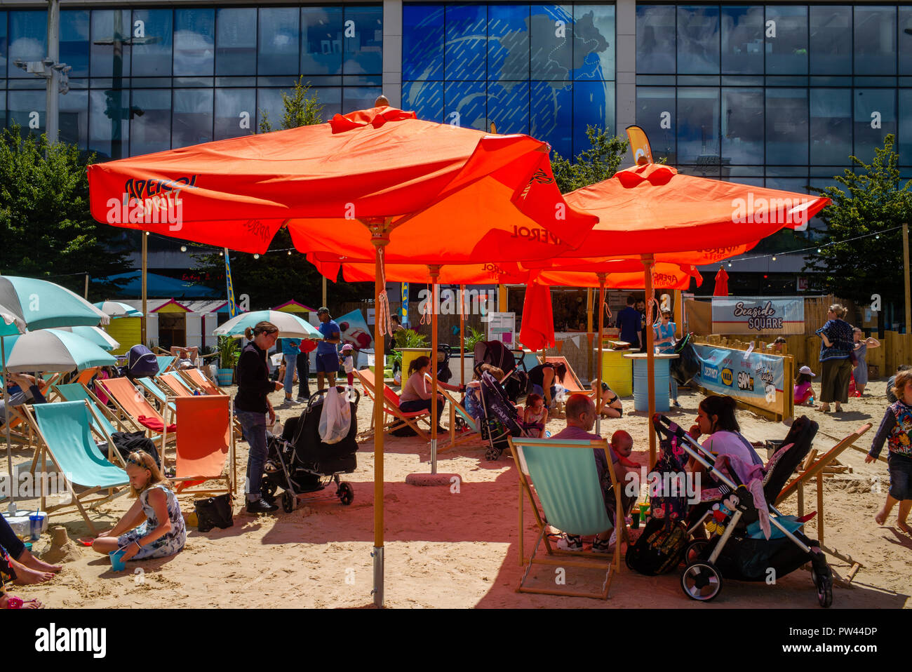 Parents and office workers alike enjoy the sunshine and relax on the ...