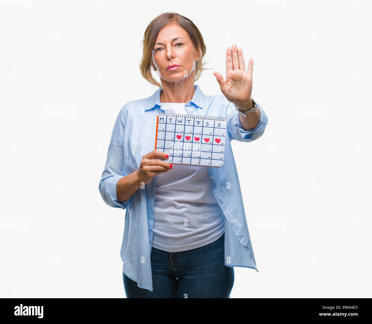 Middle age senior hispanic woman holding menstruation calendar over ...