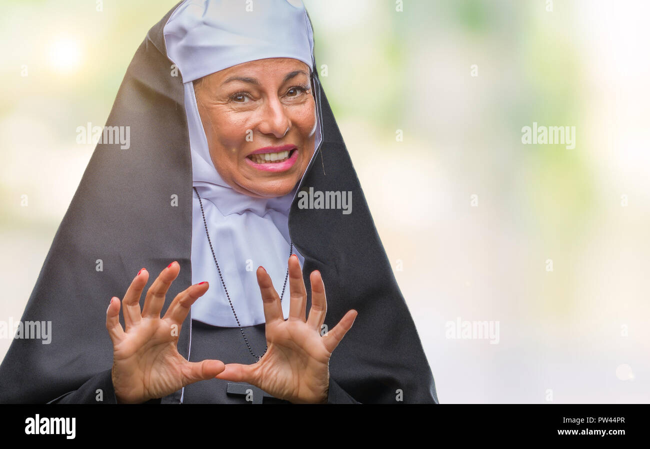 Middle age senior christian catholic nun woman over isolated background ...