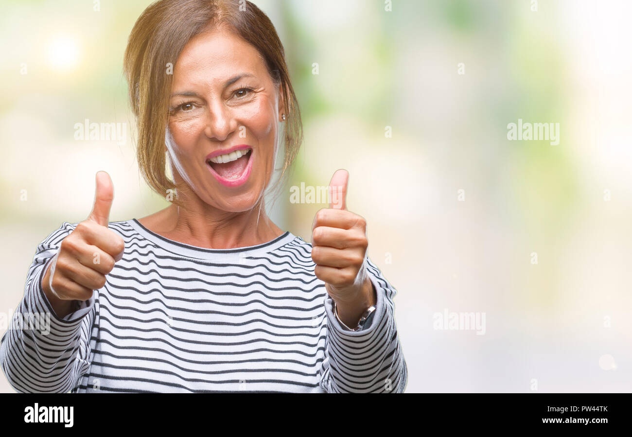 Middle age senior hispanic woman over isolated background approving ...