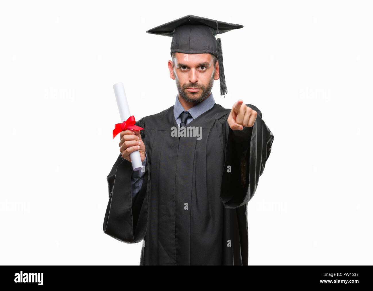 Young handsome graduated man holding degree over isolated background ...