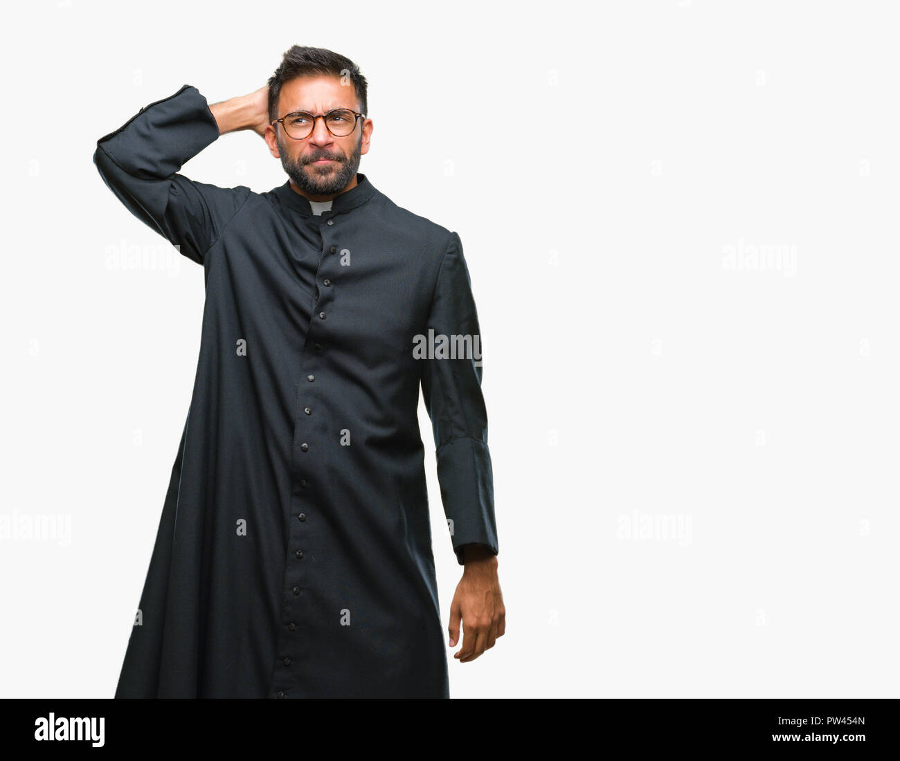 Adult hispanic catholic priest man over isolated background confuse and ...
