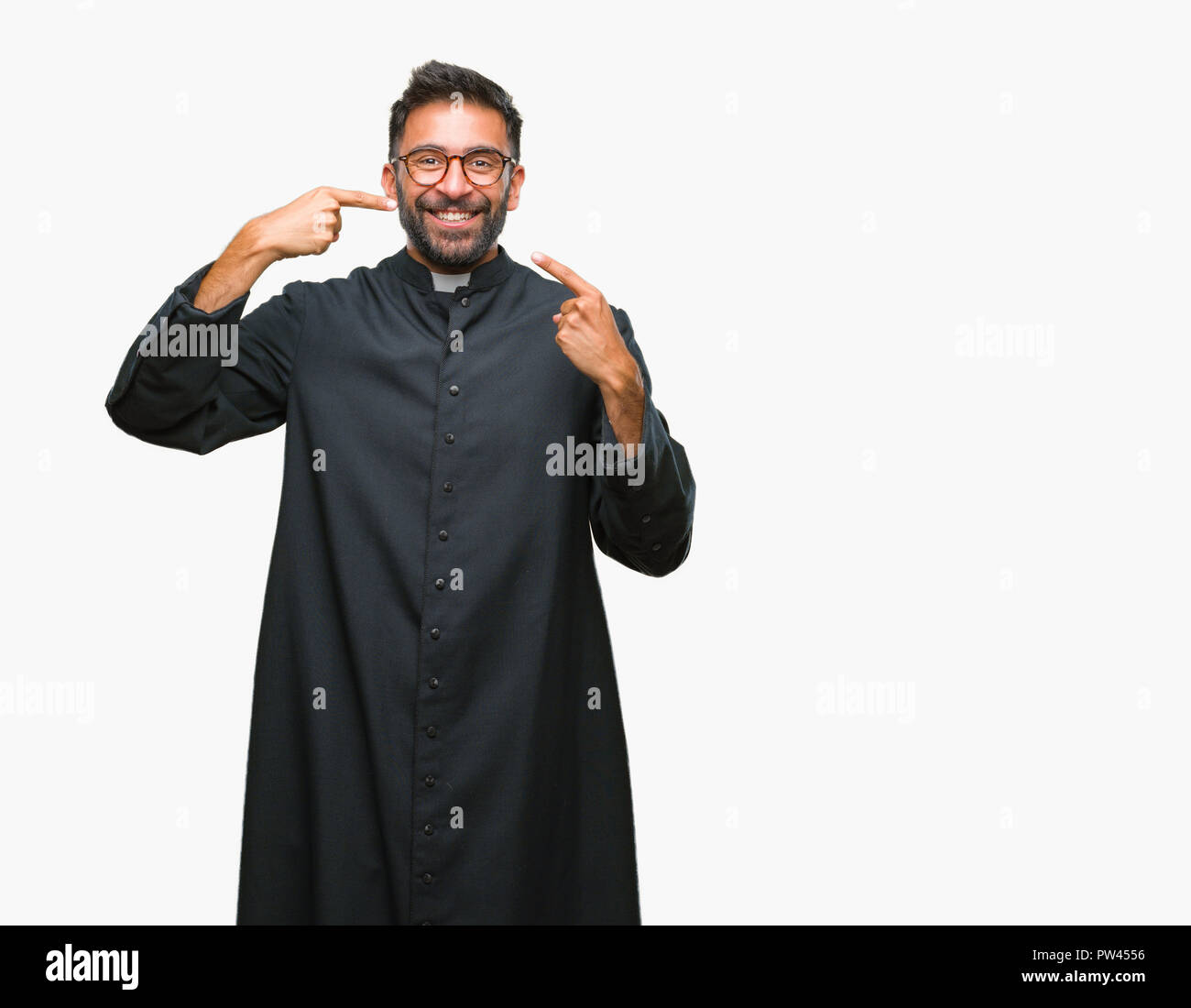 Adult hispanic catholic priest man over isolated background smiling ...