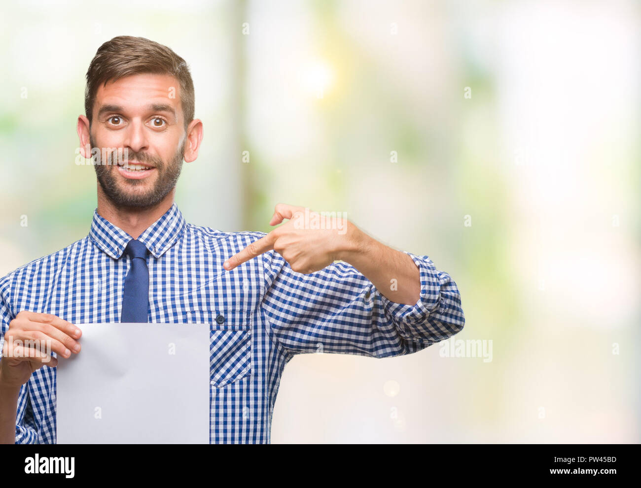 Young handsome man holding blank paper over isolated background with ...
