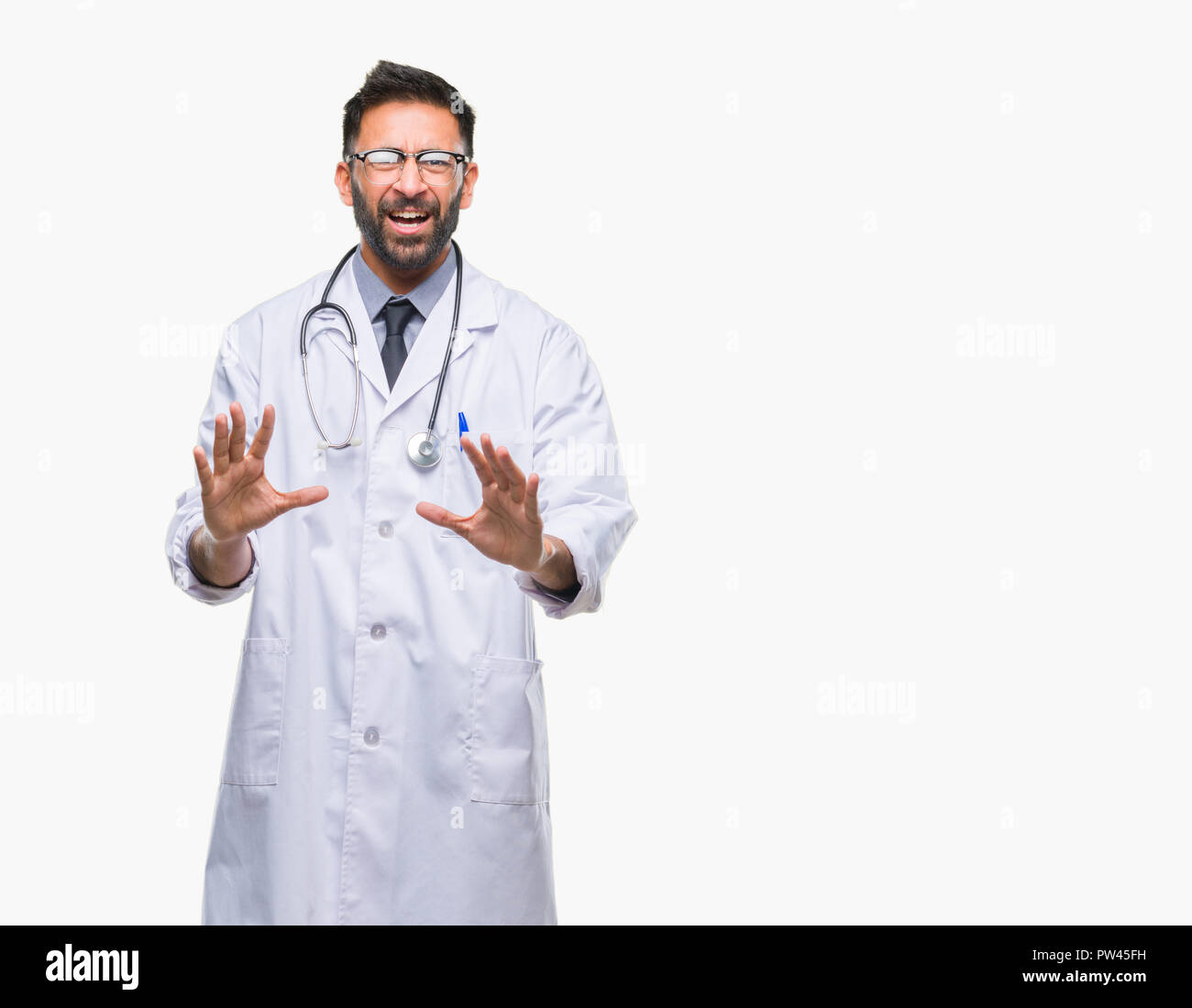 Adult hispanic doctor man over isolated background afraid and terrified ...