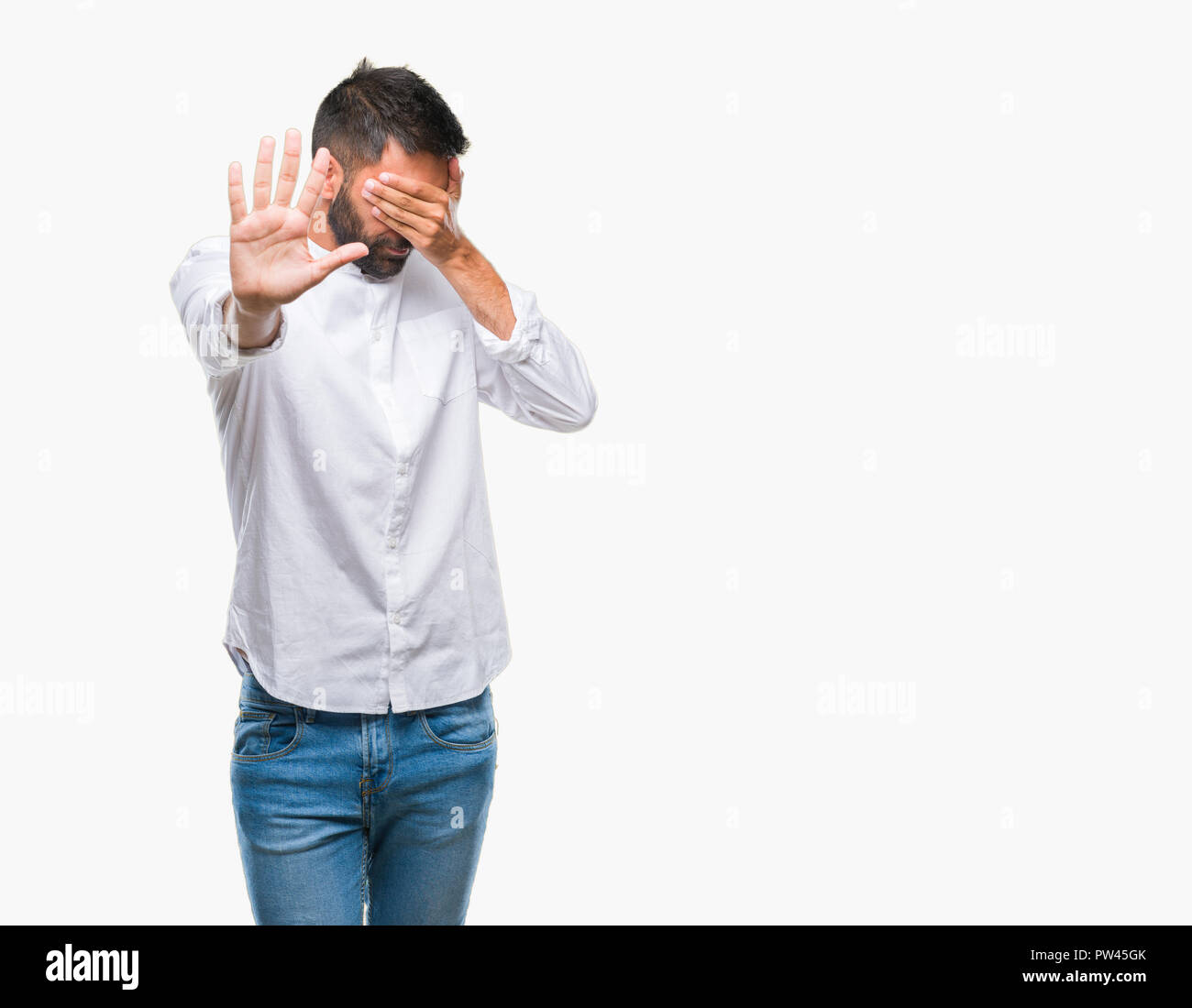 Adult hispanic man over isolated background covering eyes with hands ...