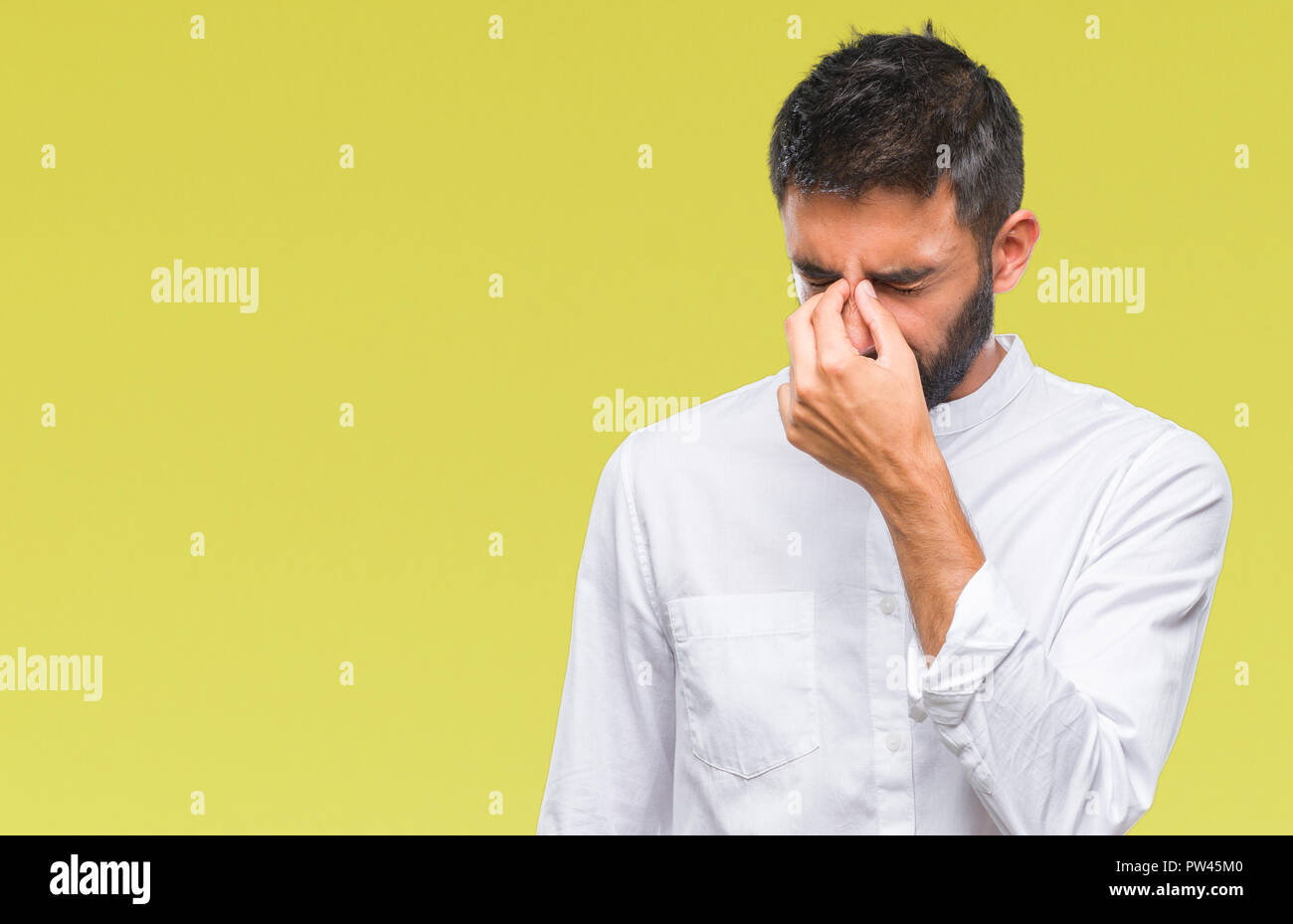 Adult hispanic man over isolated background tired rubbing nose and eyes ...