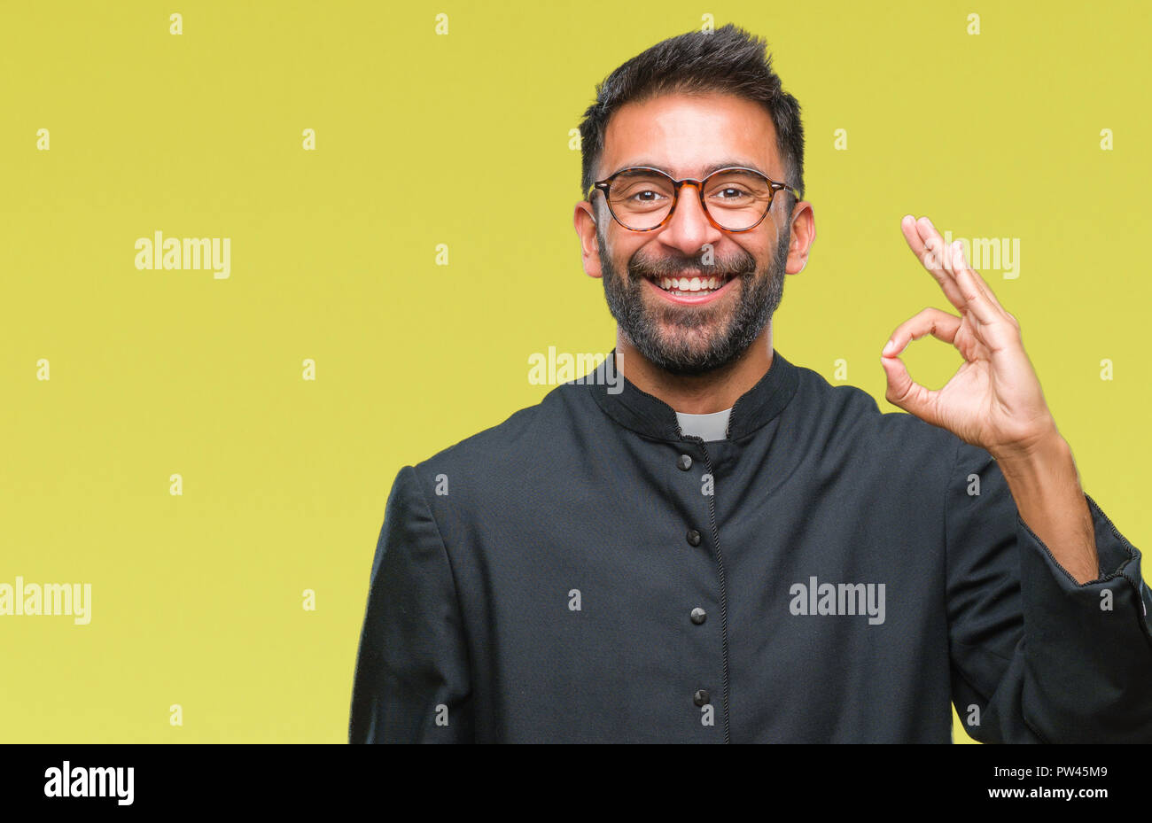 Adult hispanic catholic priest man over isolated background smiling ...