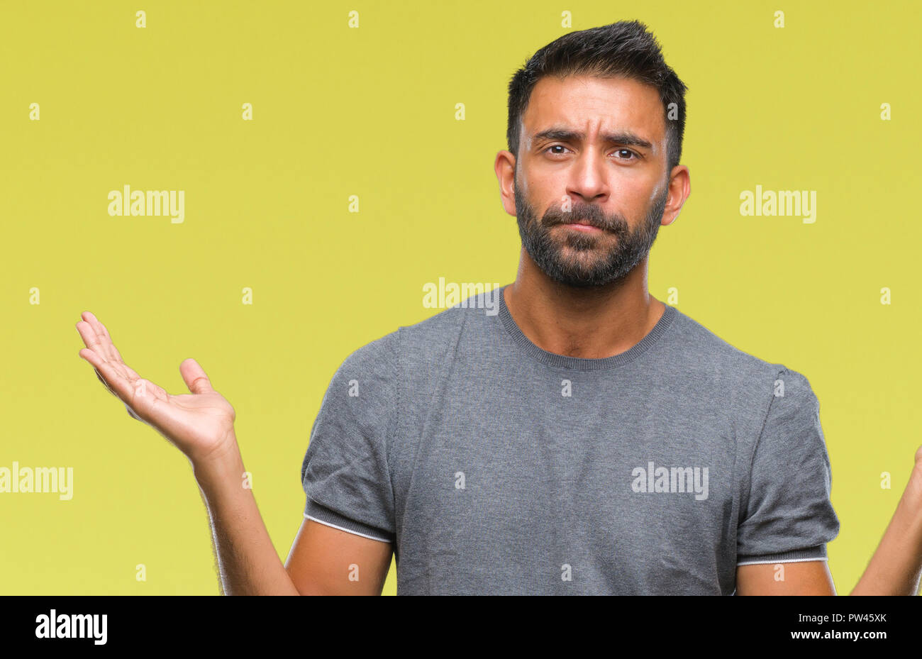 Adult hispanic man over isolated background clueless and confused ...
