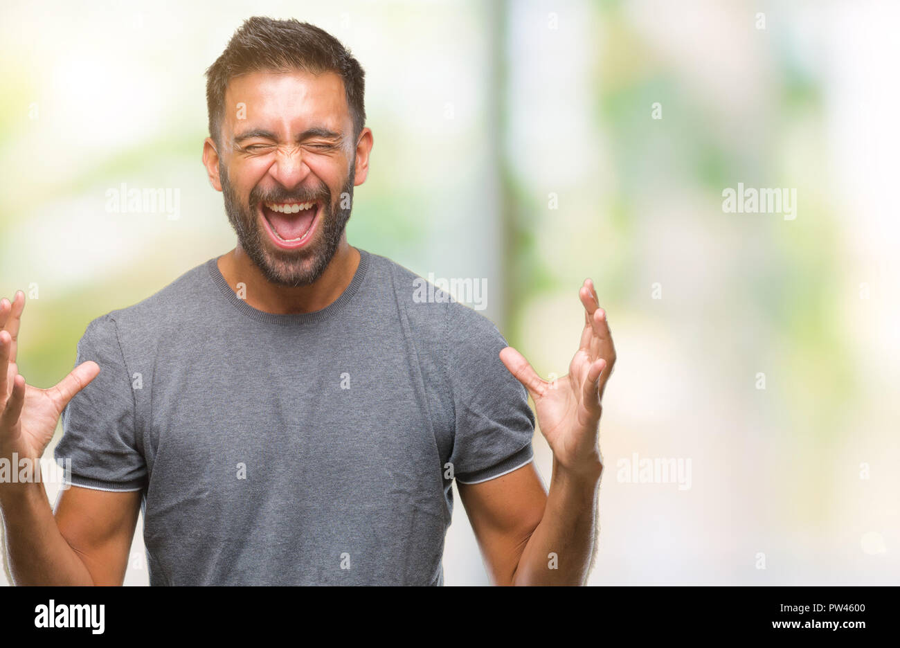 Adult hispanic man over isolated background celebrating mad and crazy ...