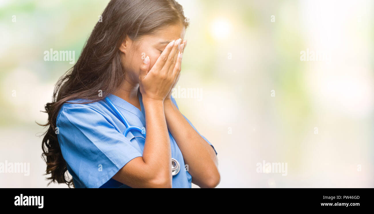 Young arab doctor surgeon woman over isolated background with sad ...