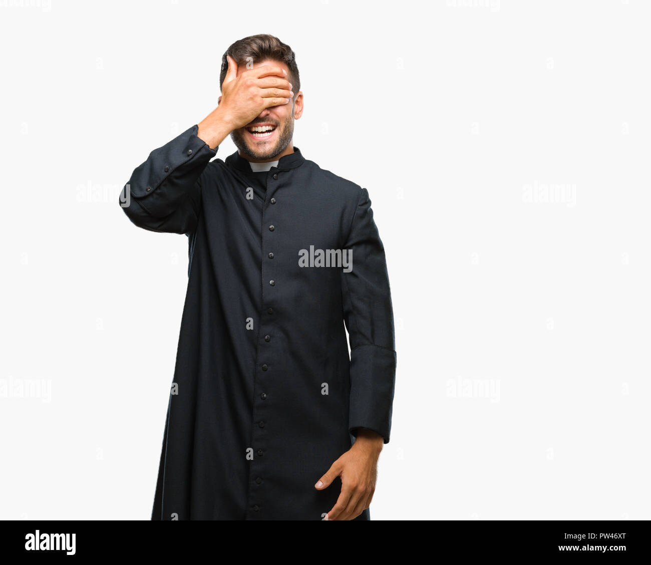 Young catholic christian priest man over isolated background smiling ...