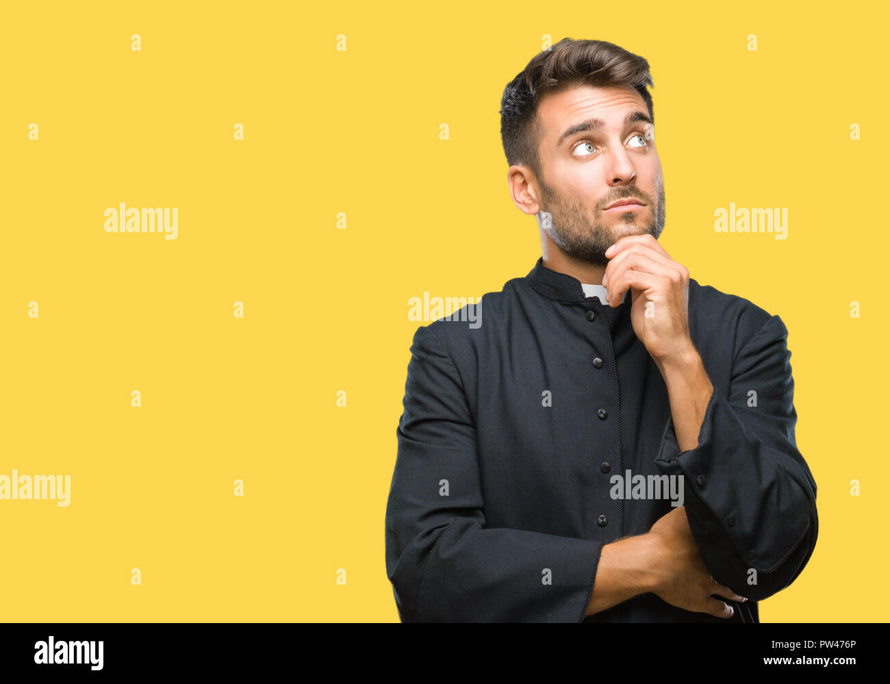 Young catholic christian priest man over isolated background with hand ...
