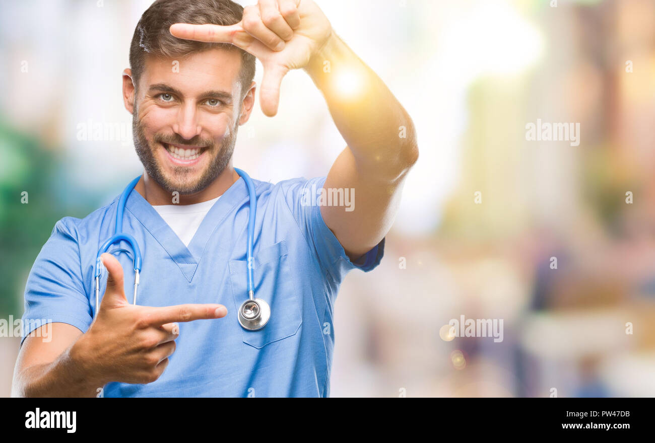 Young handsome doctor surgeon man over isolated background smiling ...