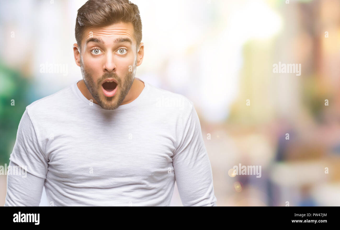 Young handsome man over isolated background afraid and shocked with surprise expression, fear ...