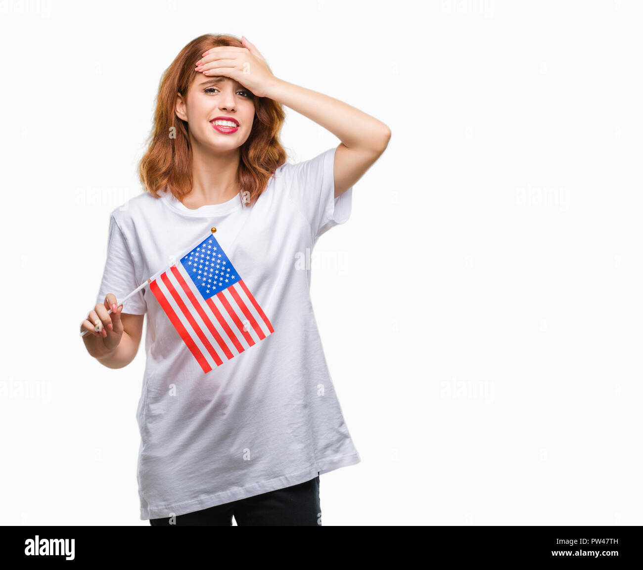 Young beautiful woman holding flag of america over isolated background ...