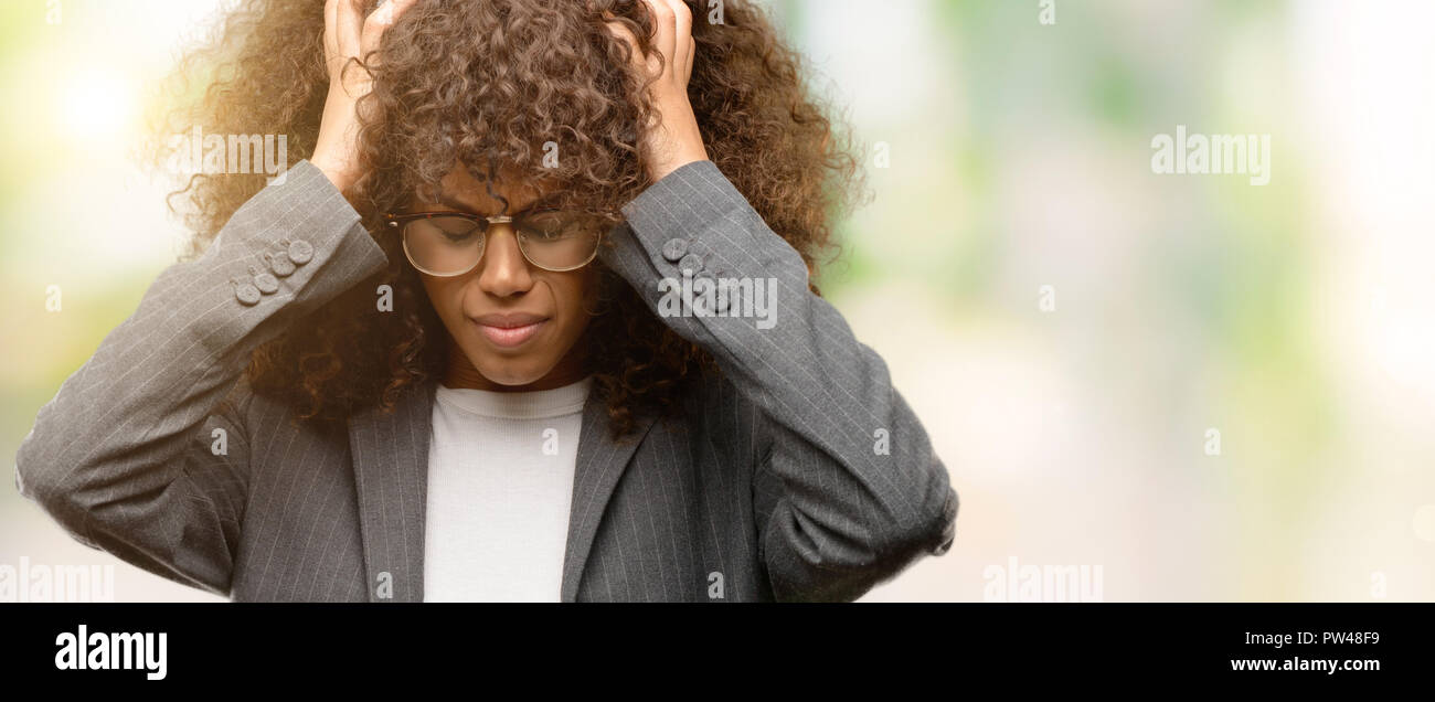 African american business woman wearing glasses suffering from headache ...