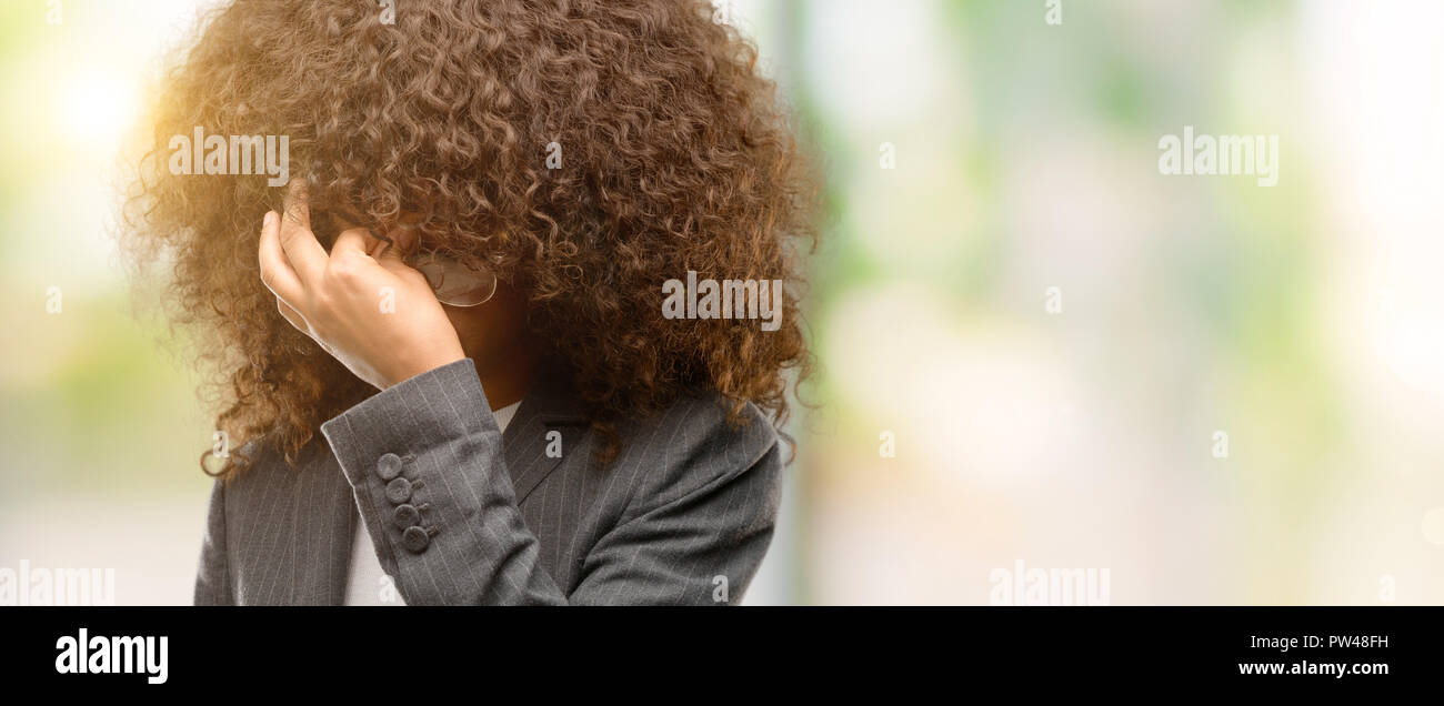 African american business woman wearing glasses tired rubbing nose and ...